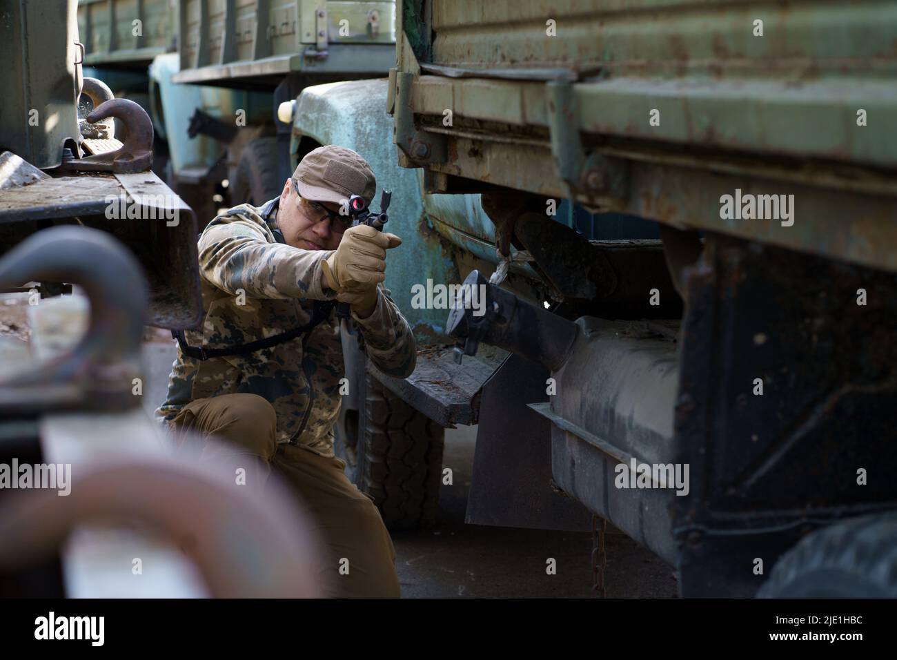 Defensive tactics shooter course, man with a gun in military uniform ...