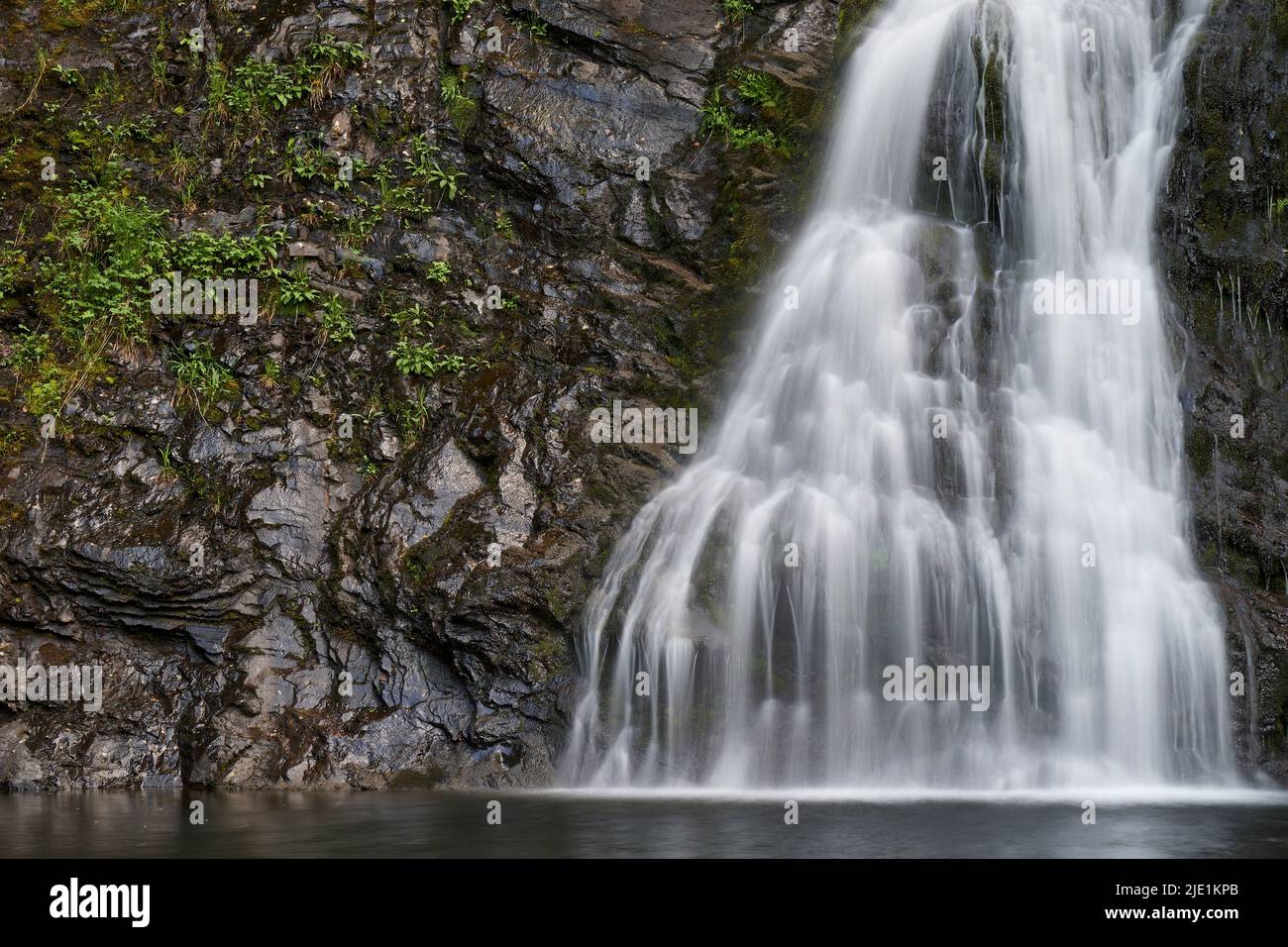 Waterfall cascading into pool Stock Photo - Alamy