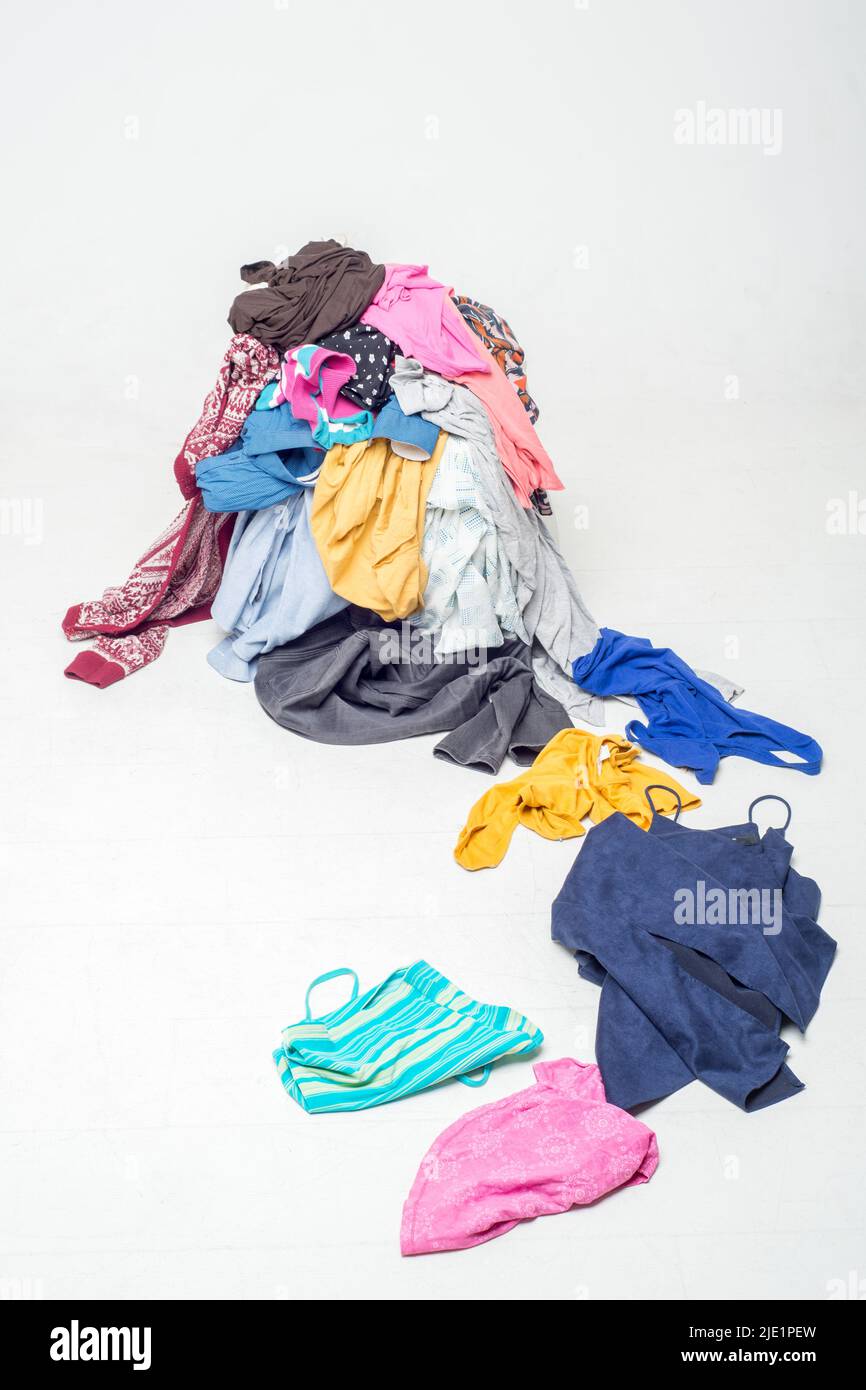 pile of used clothes on a light background. Second hand for recycling ...