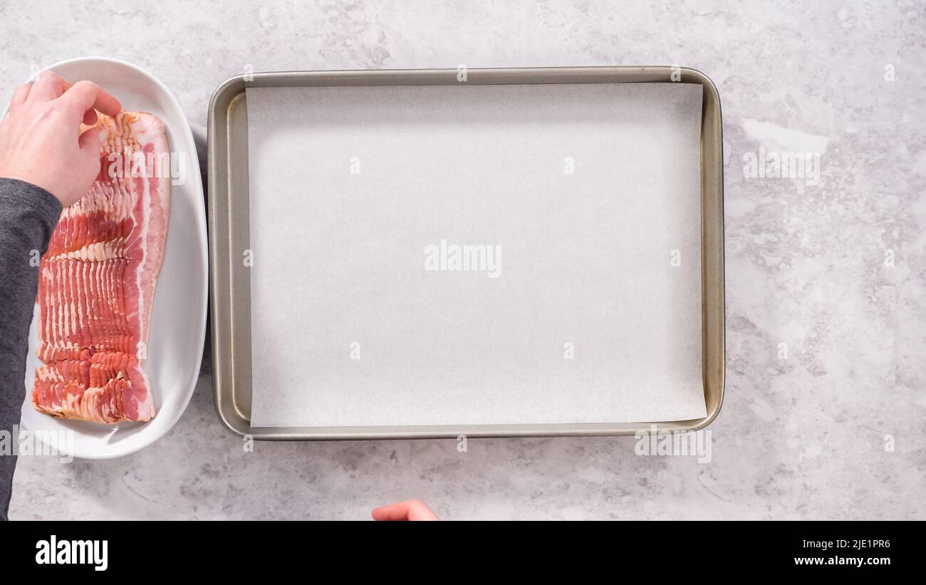 Flat lay. Step by step. Uncooked bacon strips on a baking sheet with ...
