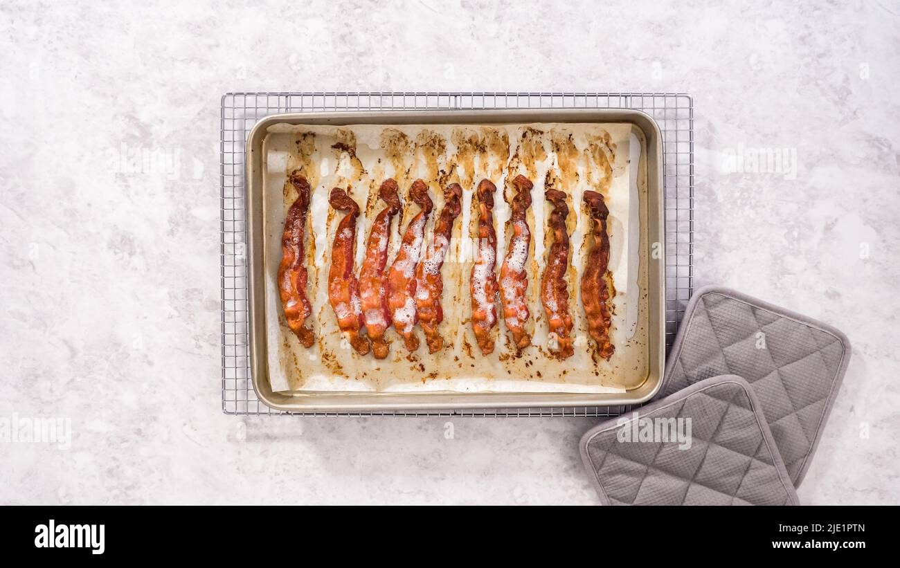 Flat lay. Step by step. Cooked bacon strips on a baking sheet with ...