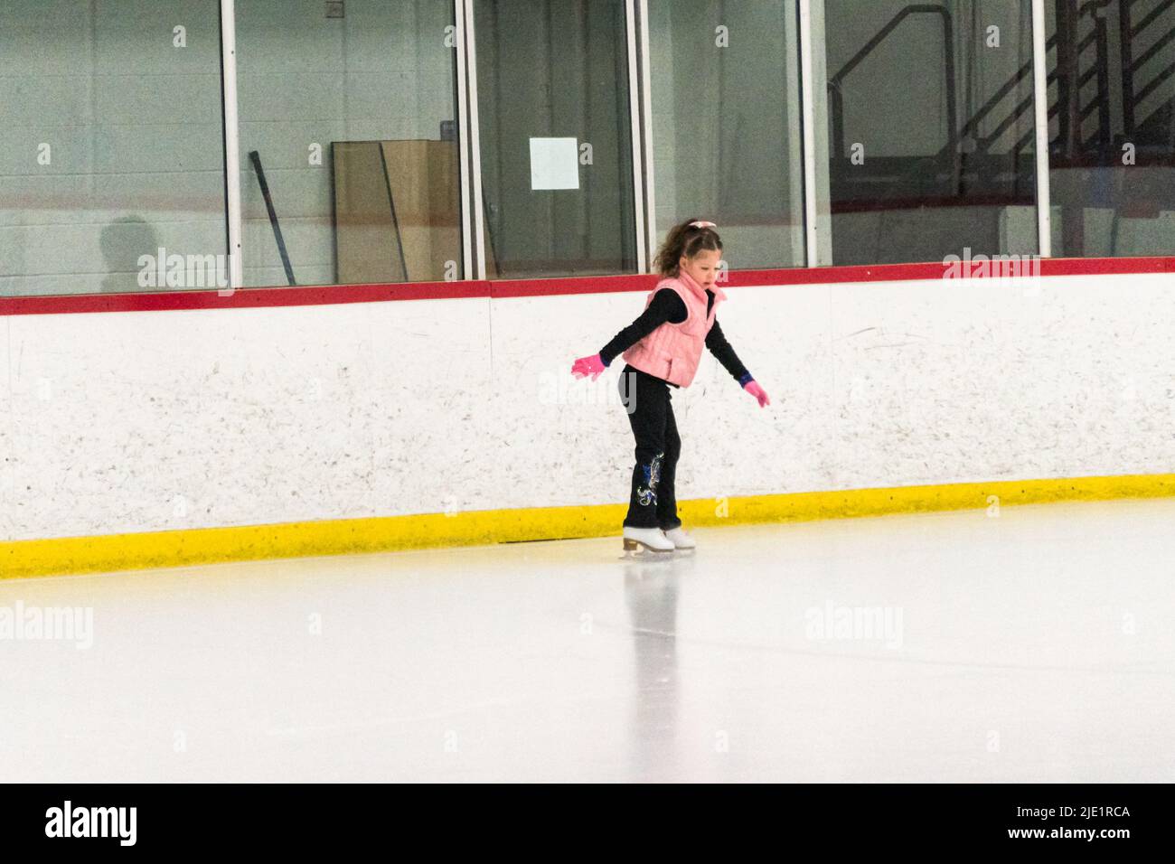 Little skater practicing her elements at the morning figure skating ...