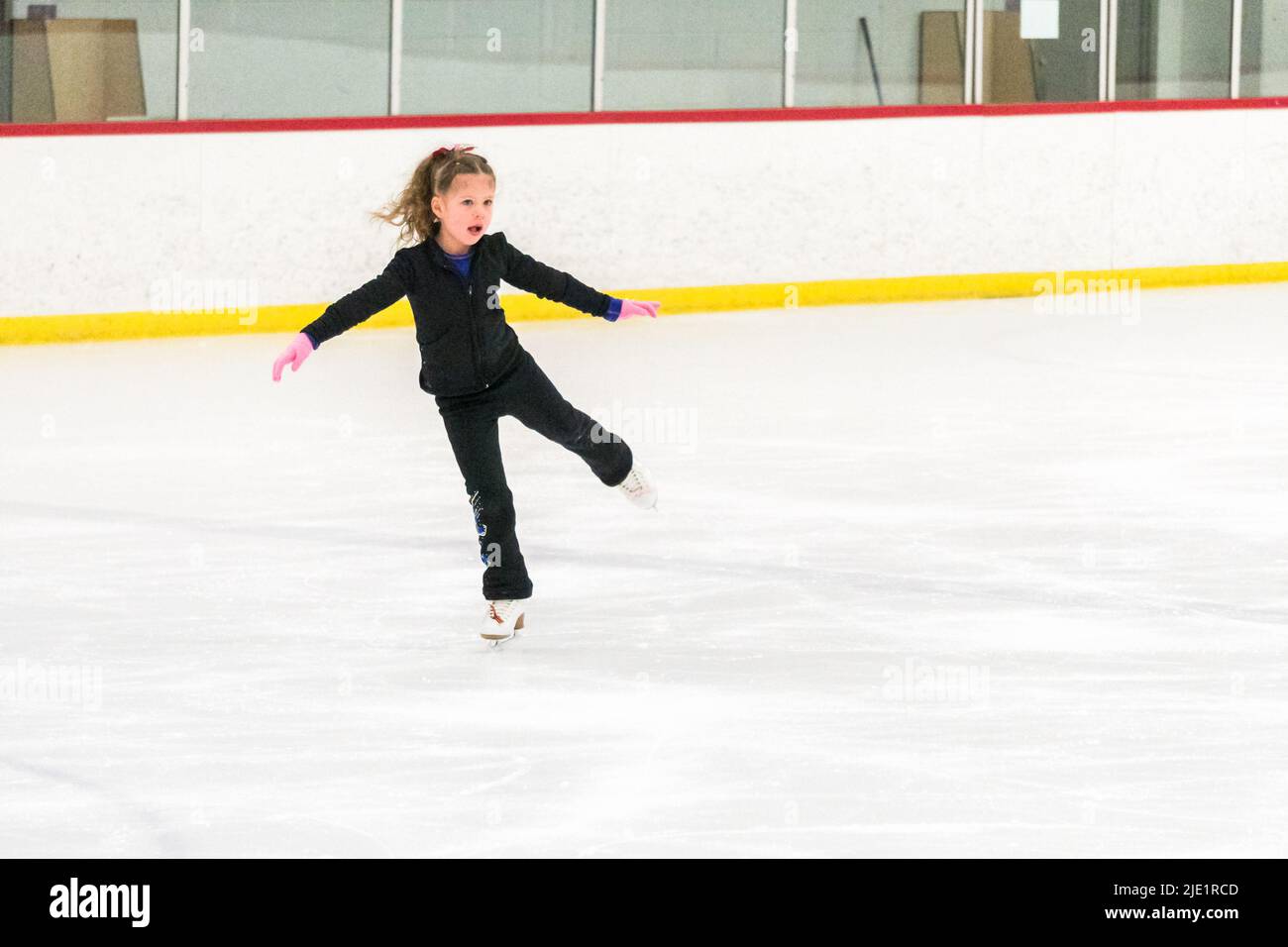 Little skater practicing her elements at the morning figure skating ...