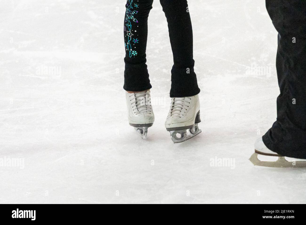 View of a figure skater and her coach feet at the figure skating ...