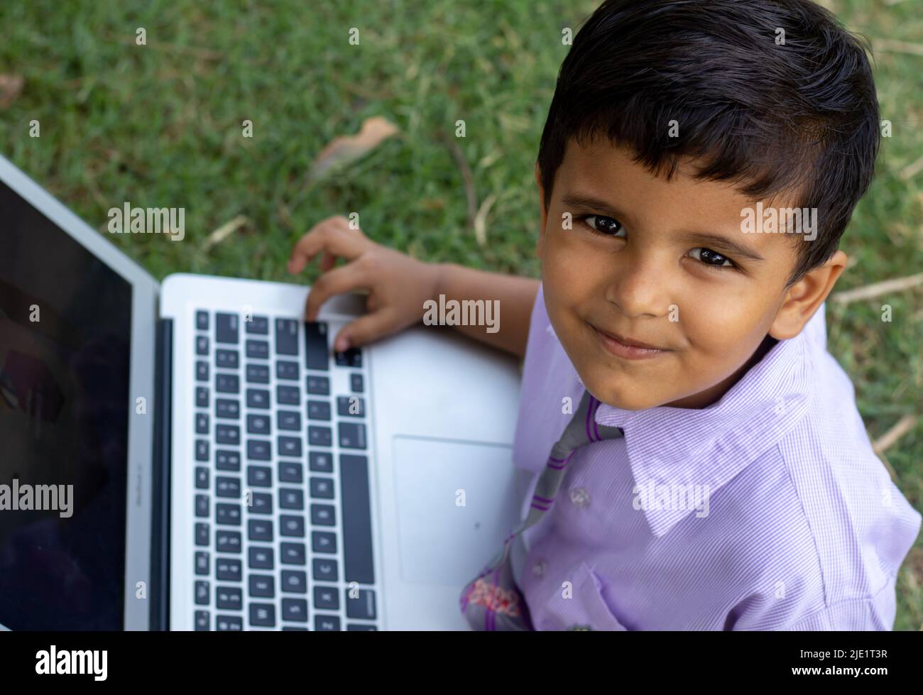 Little school kid using laptop at outdoor of rural area Stock Photo - Alamy