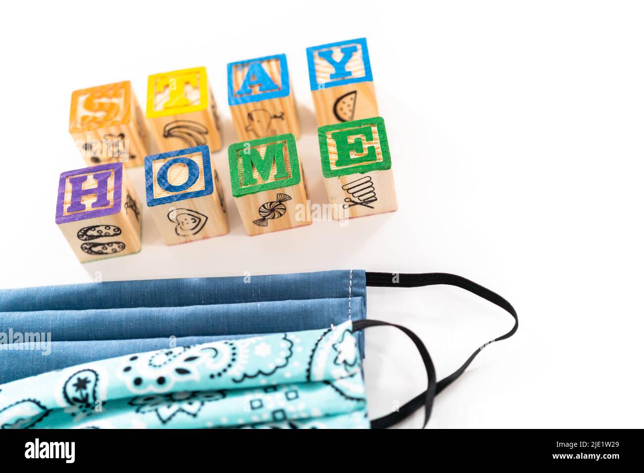 STAY HOME sign out of kids' alphabet blocks with homemade face masks on ...