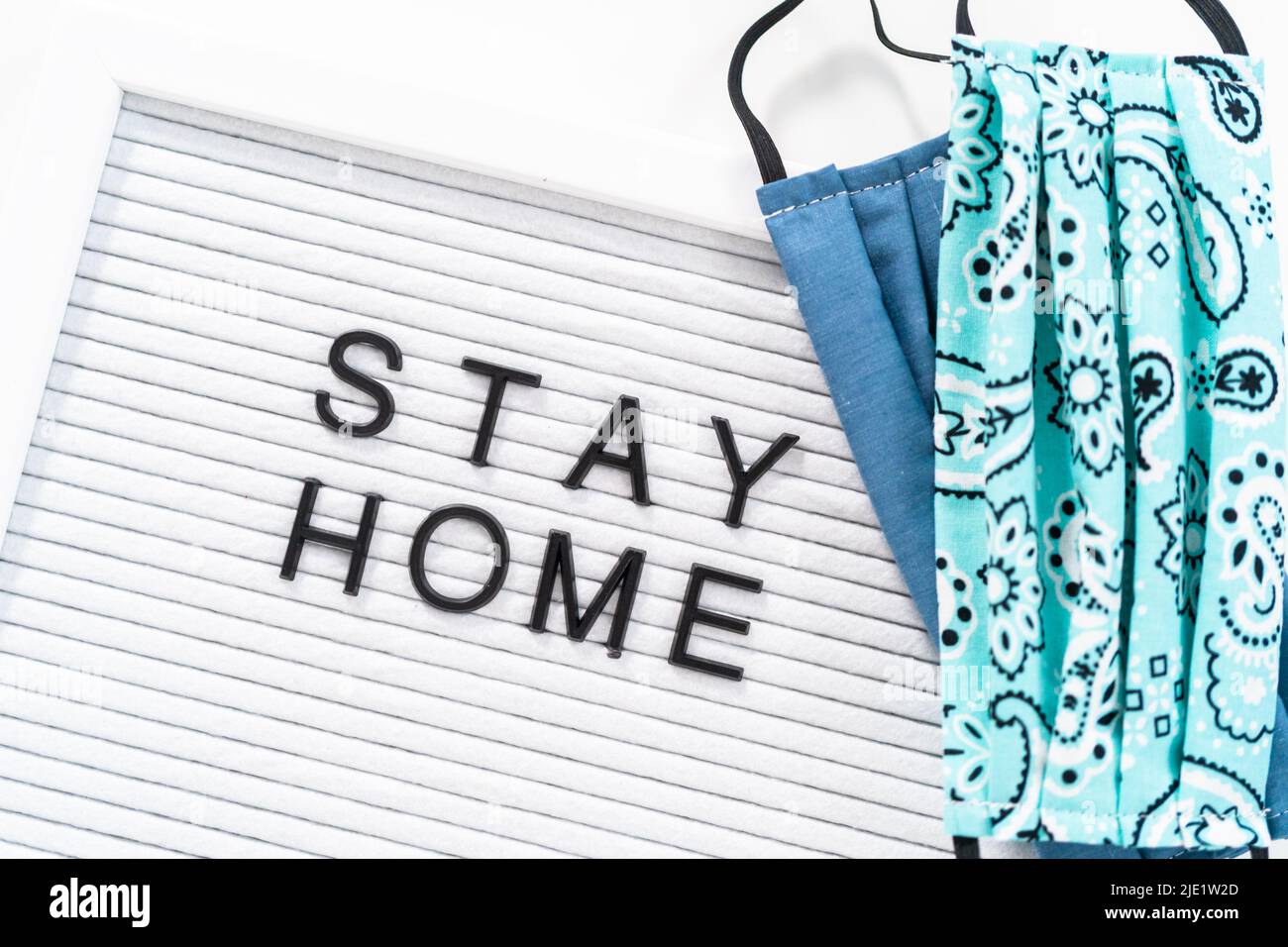 STAY HOME sign on message board with a homemade face mask Stock Photo ...