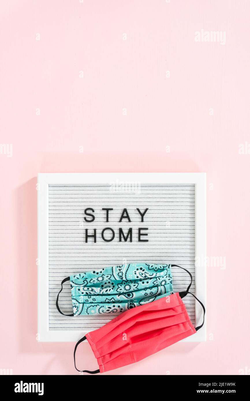 STAY HOME sign on message board with a homemade face mask Stock Photo ...