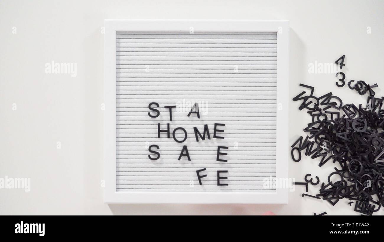 Flat lay. STAY HOME and STAY SAFE sign on a white message board Stock ...