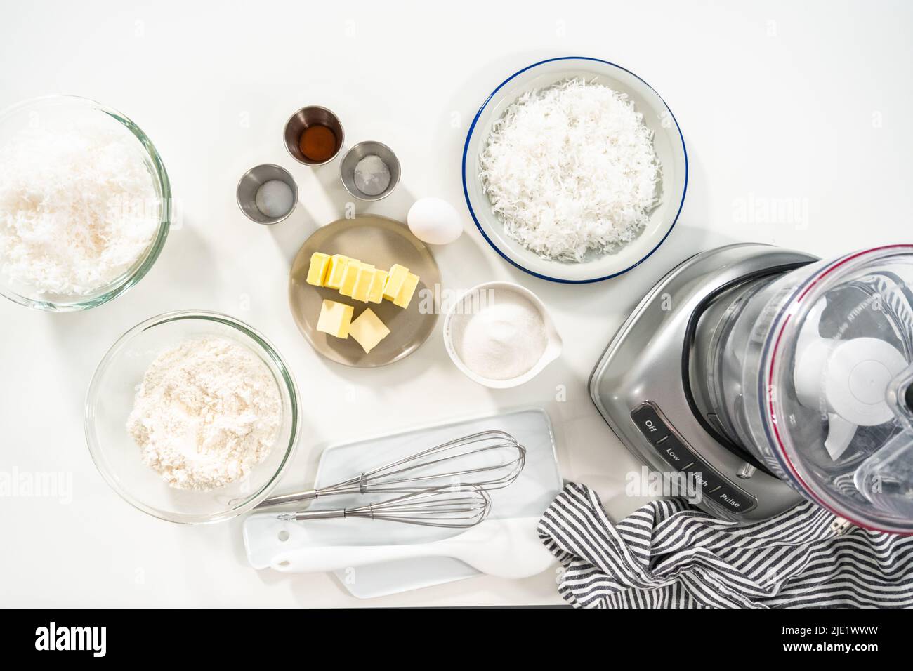 Flat lay. Ingredient to bake coconut cookies on the kitchen counter ...