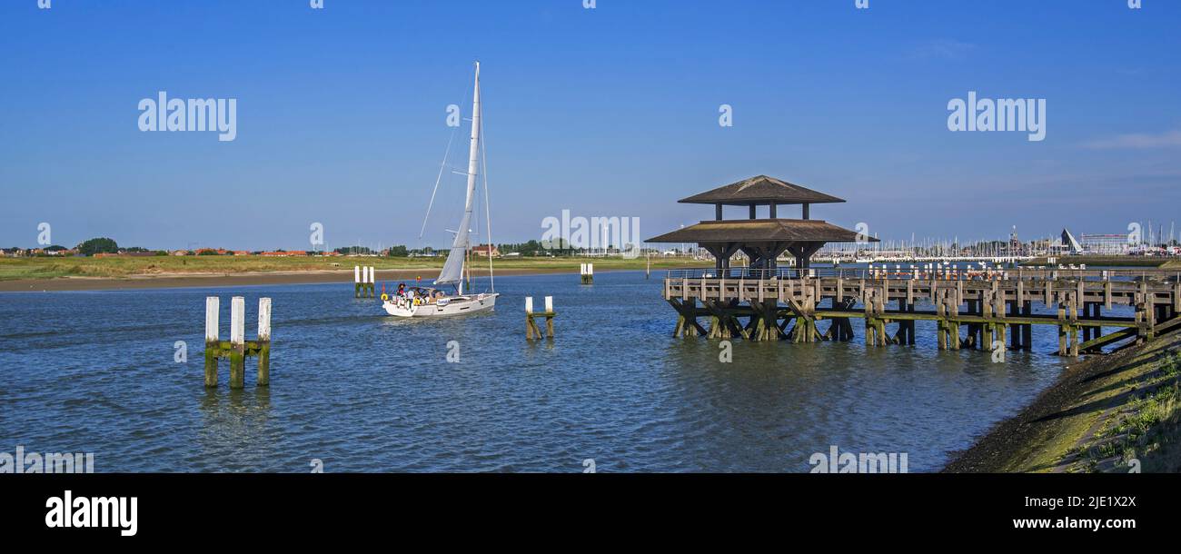 Wooden observation tower / watchtower and sailing boat entering the ...