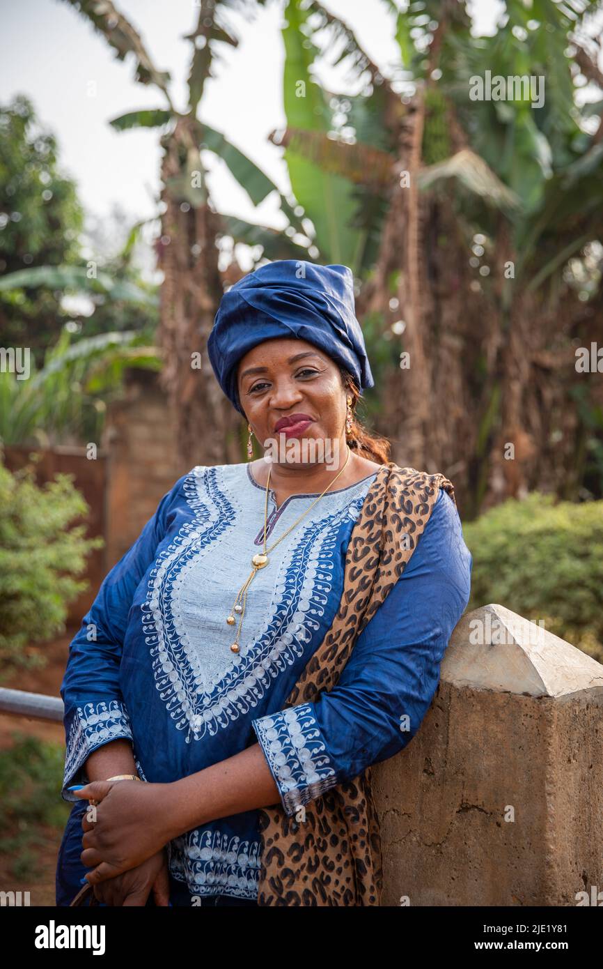 Portrait of a smiling mature African woman dressed in traditional ...