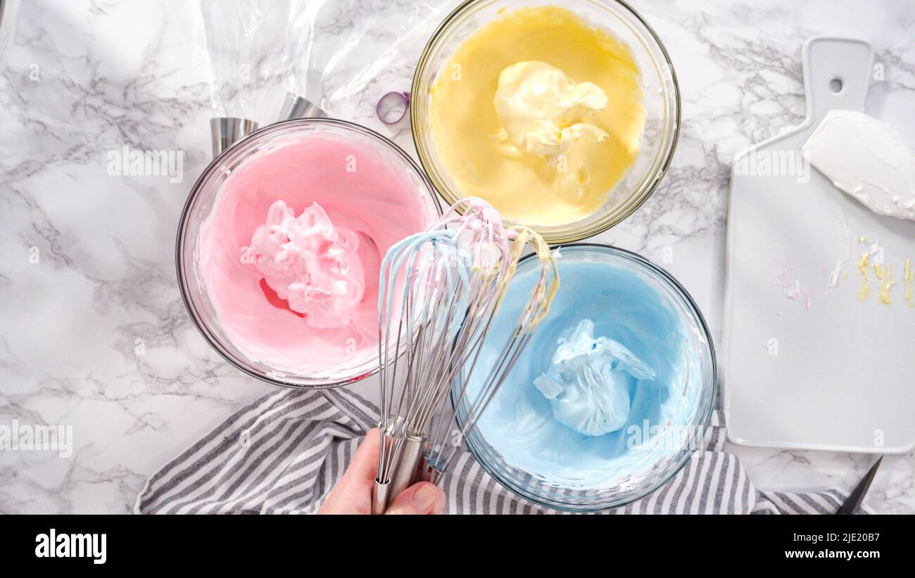 Step by step. Flat lay. Mixing food coloring into the meringue to bake ...