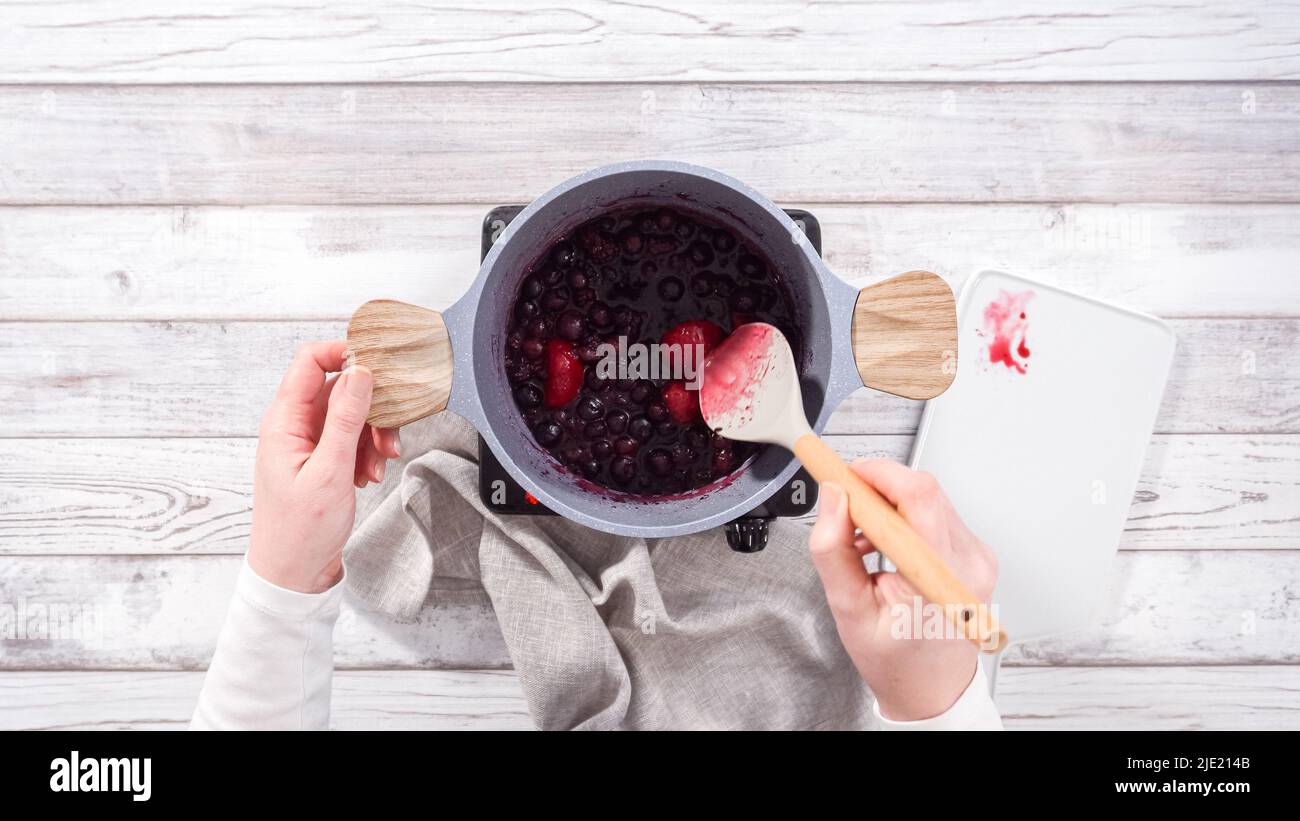 Step by step. Preparing mixed berry compote from frozen berries in a ...