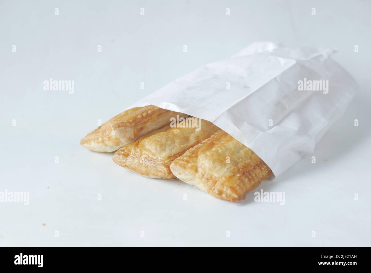 slice of apple pie cake in a take away packet on white Stock Photo - Alamy