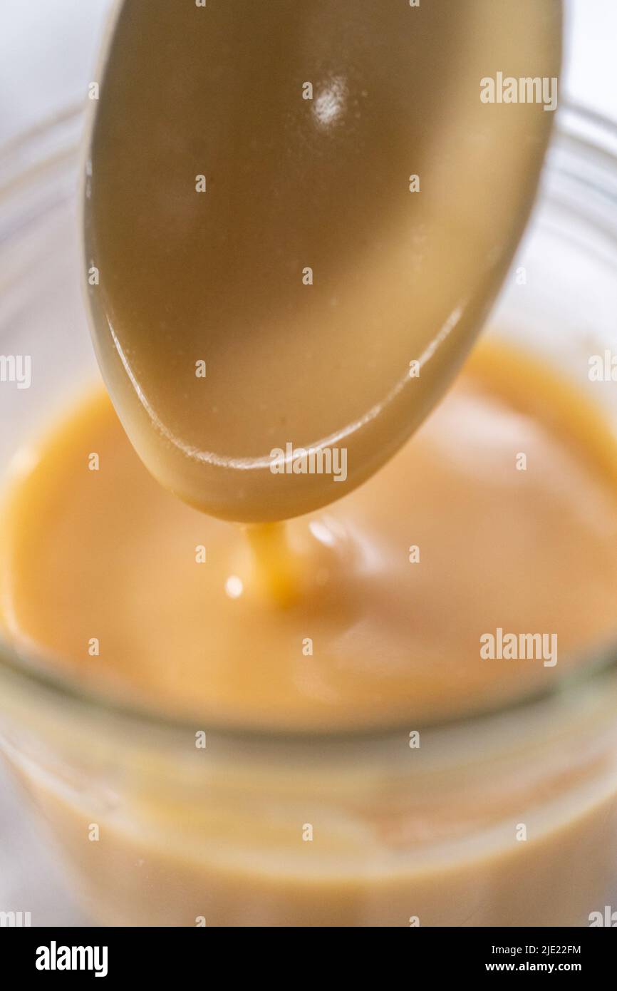 Homemade toffee glaze in a glass jar on the kitchen counter Stock Photo ...