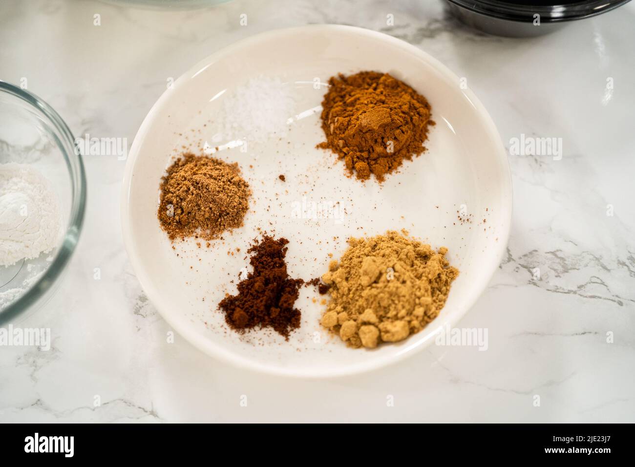 Measured ingredients in glass mixing bowls to bake gingerbread cupcakes ...