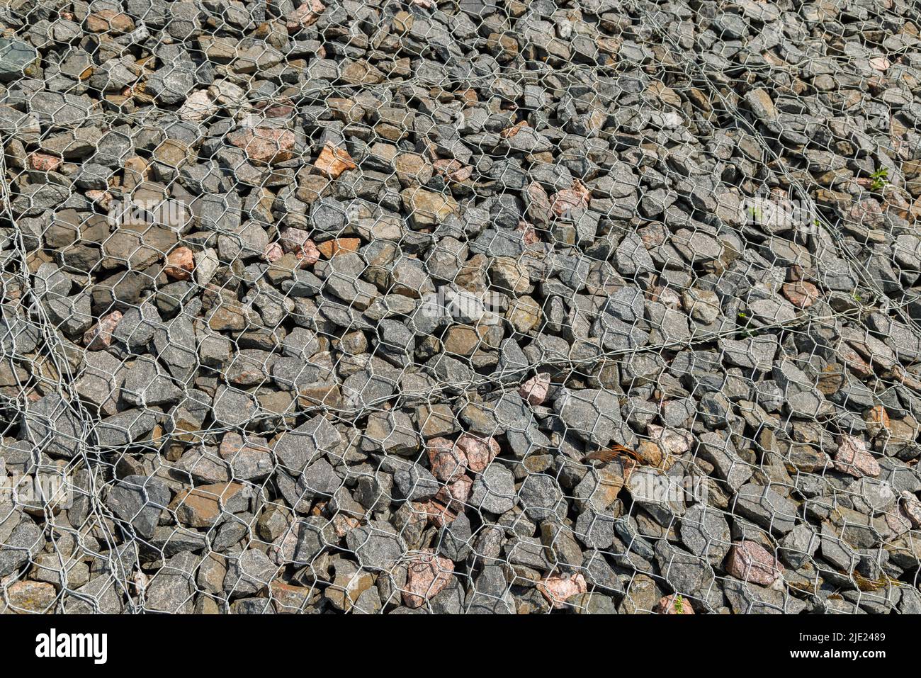 granite gravel reinforcement of road embankment covered wth steel mesh ...
