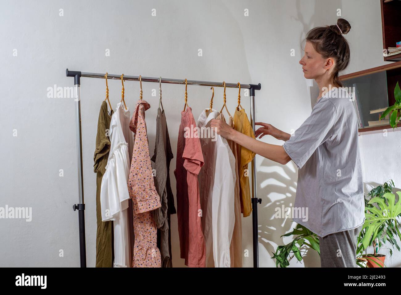 Woman sorting clothes home hi-res stock photography and images - Alamy