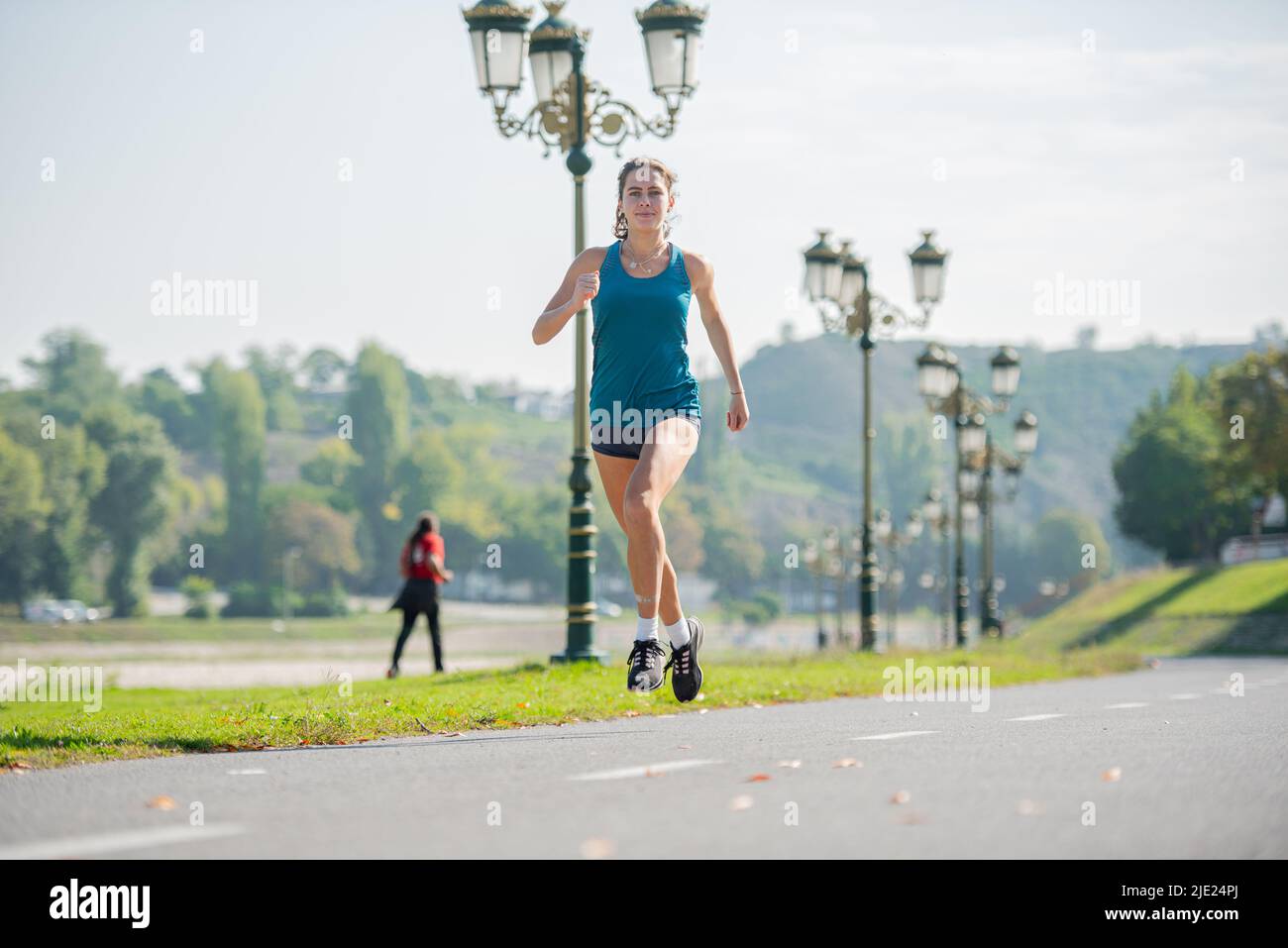 Attractive adn beautiful fit girl is running fast to warm up her body ...