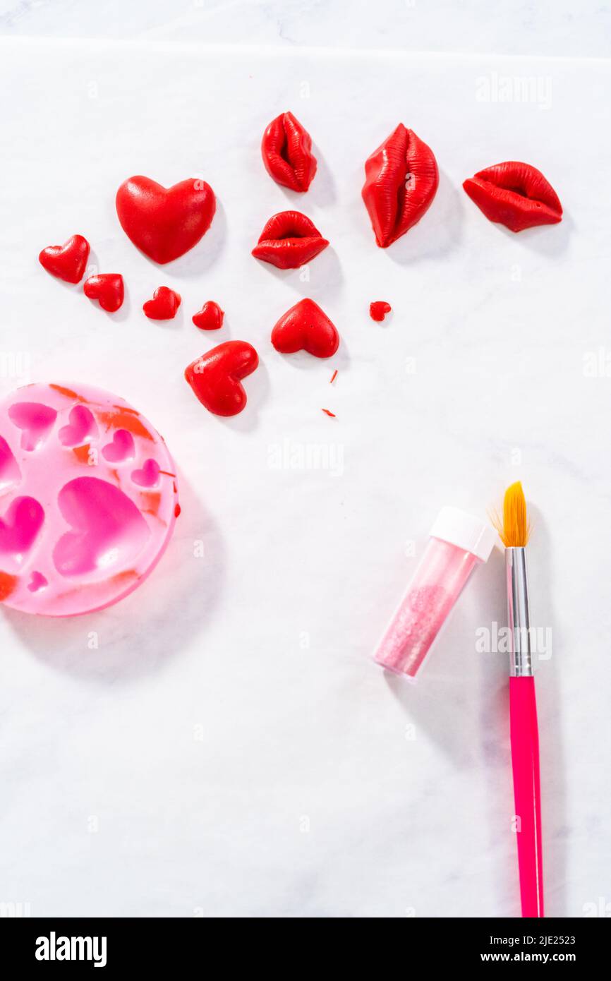 Dusting chocolate lips and heart-shaped chocolates with editable ...