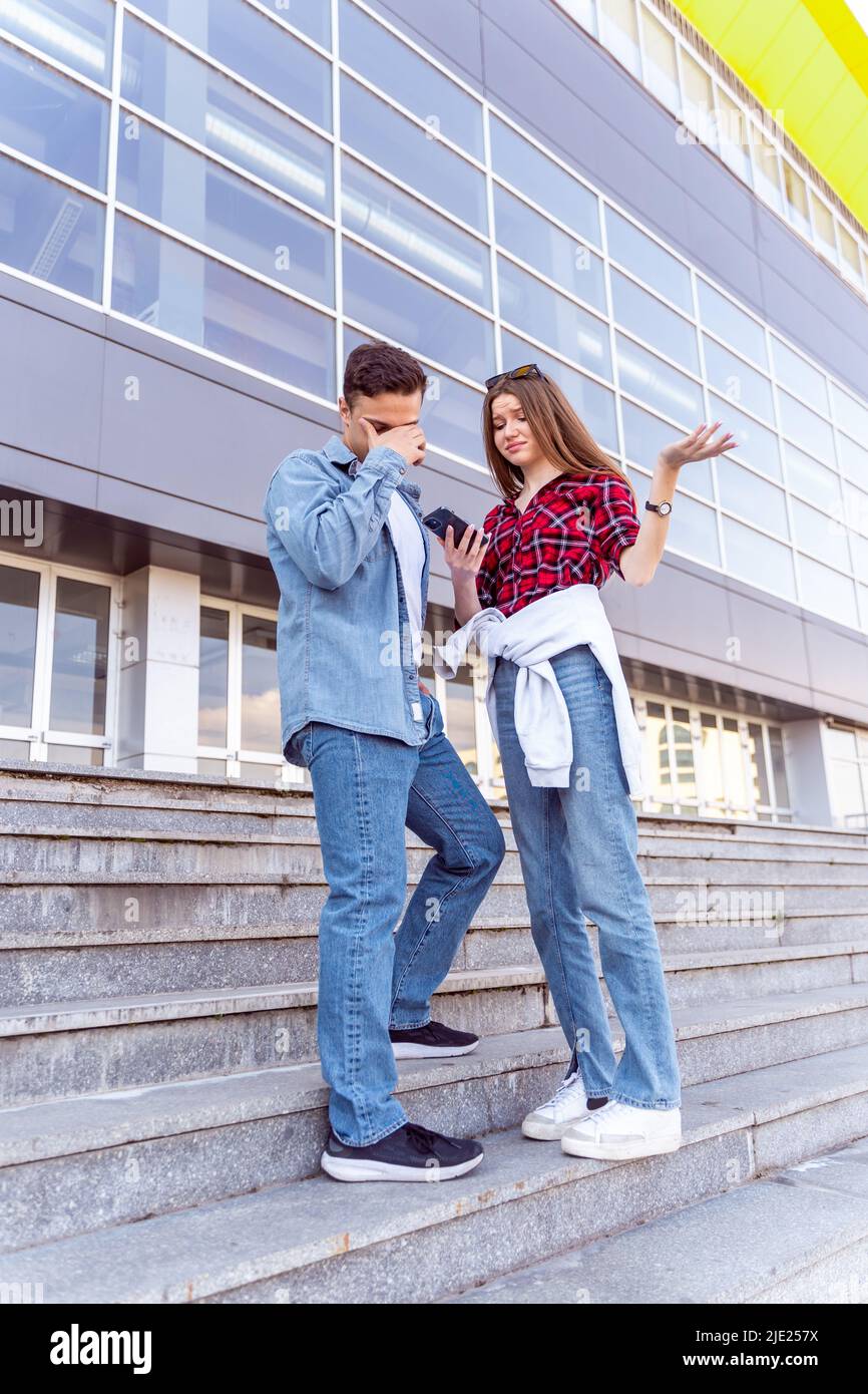 Cute couple having argument while standing on the stairs Stock Photo ...