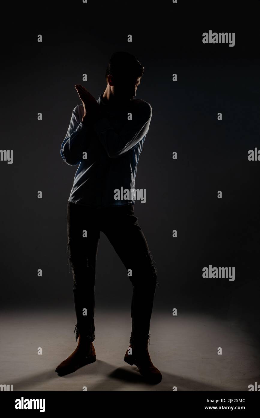 Attractive and handsome man in the studio setting himself up for the ...