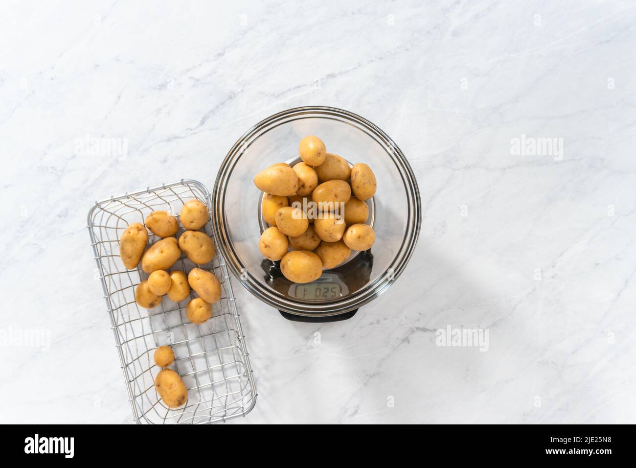 Flat lay. Pressure Cooker Baked Potatoes. Measuring raw potatoes in a ...