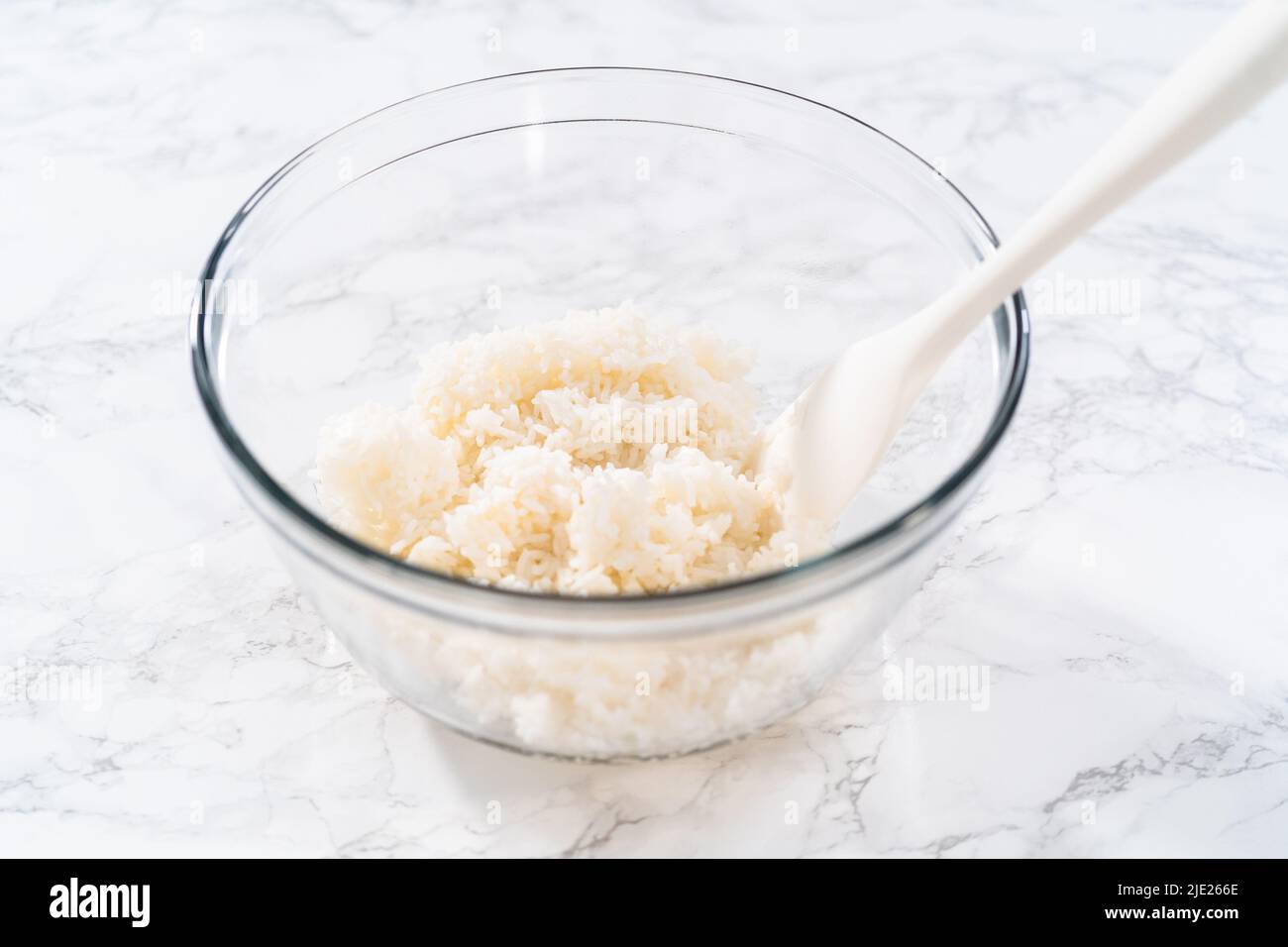 Cilantro Lime Rice. Mixing ingredients in a glass mixing bowl to ...