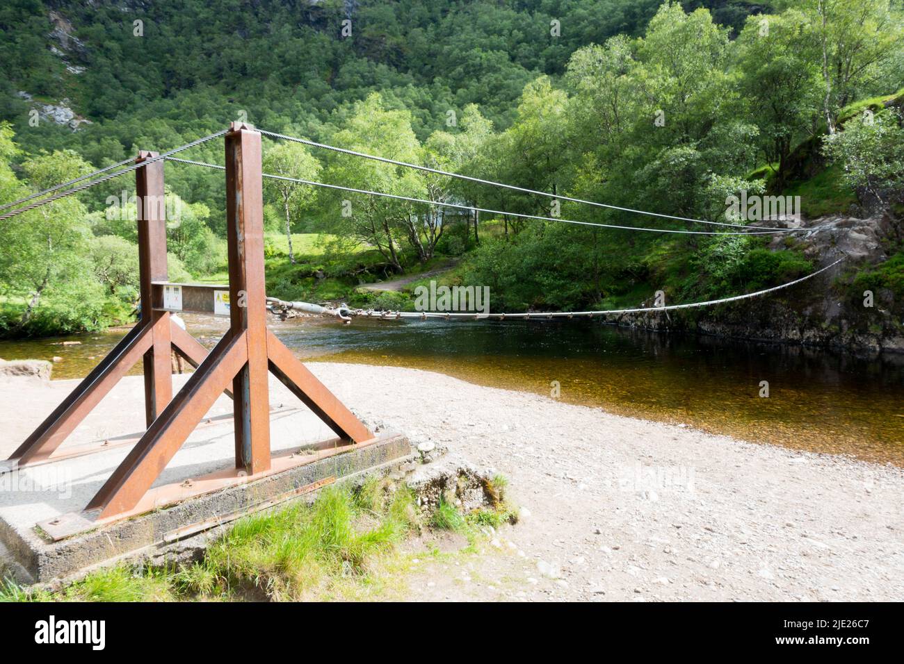 Metal structure holding three steel wires used as a foot bridge to ...