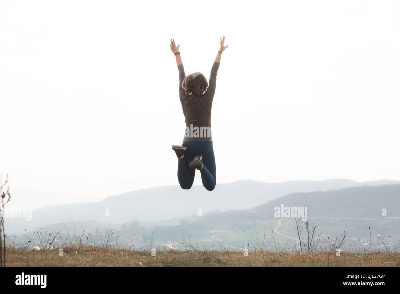 Amazing and active woman is jumping Stock Photo - Alamy