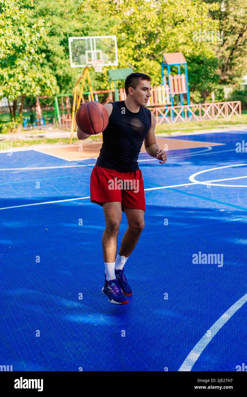 Basketball player jump shooting and playing basketball Stock Photo - Alamy