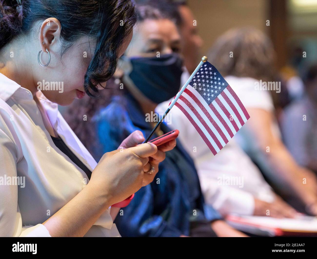 Austin Texas USA, June 24 2022: A soon-to-be new citizen sends a text ...