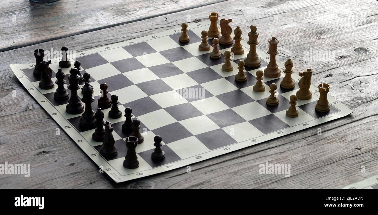 a professional tournament chess board with the 32 chess game pieces ...