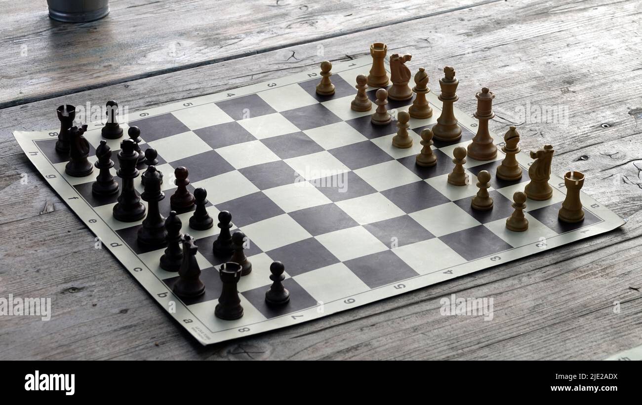 a professional tournament chess board with the 32 chess game pieces ...
