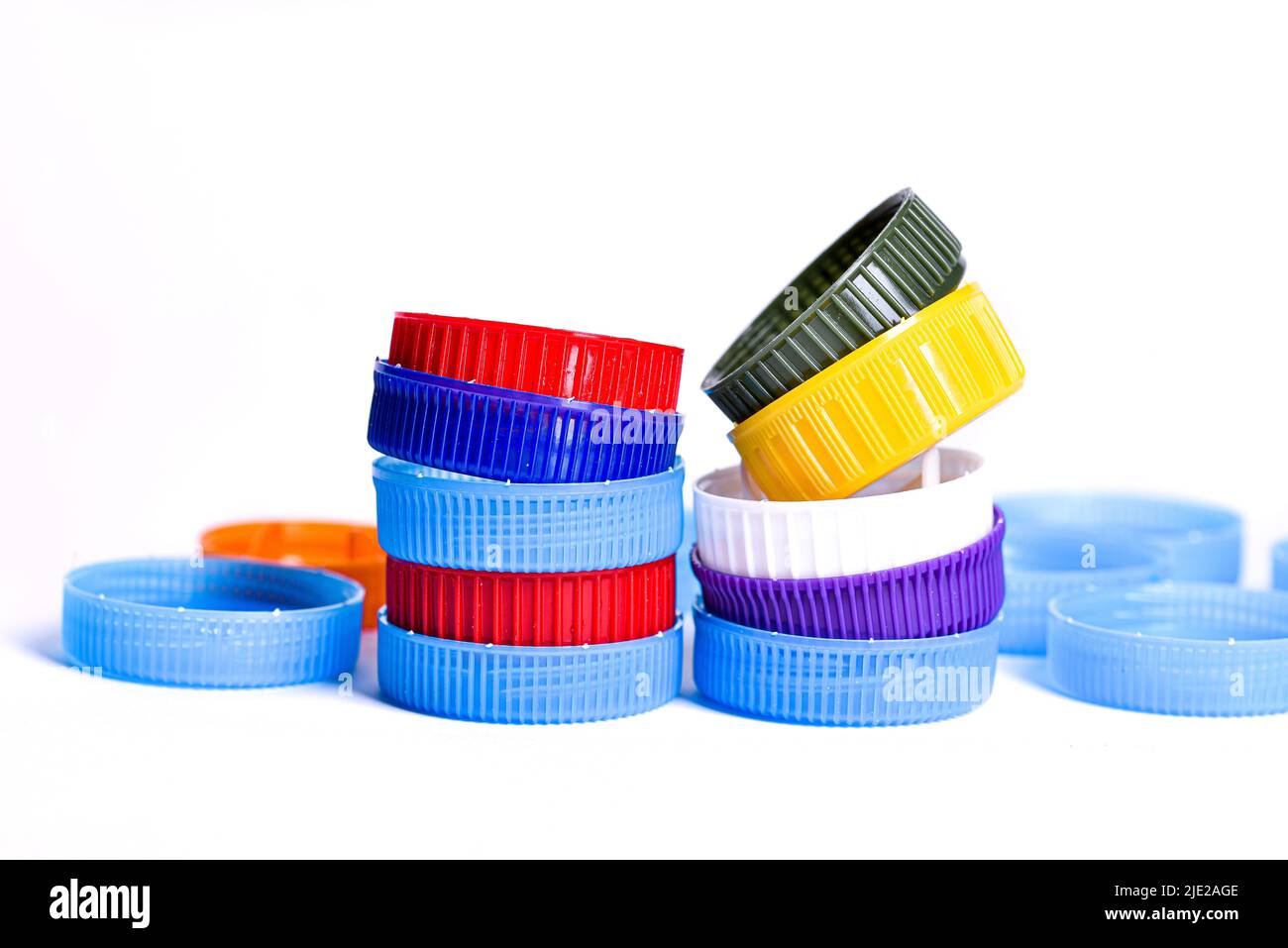 Big colored bottle plastic cap zero waste recycling on white background ...
