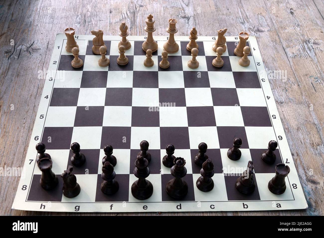 a professional tournament chess board with the 32 chess game pieces ...