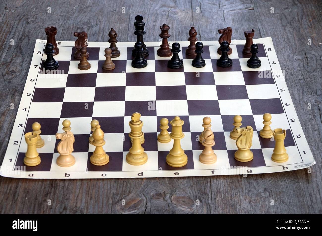 a professional tournament chess board with the 32 chess game pieces ...