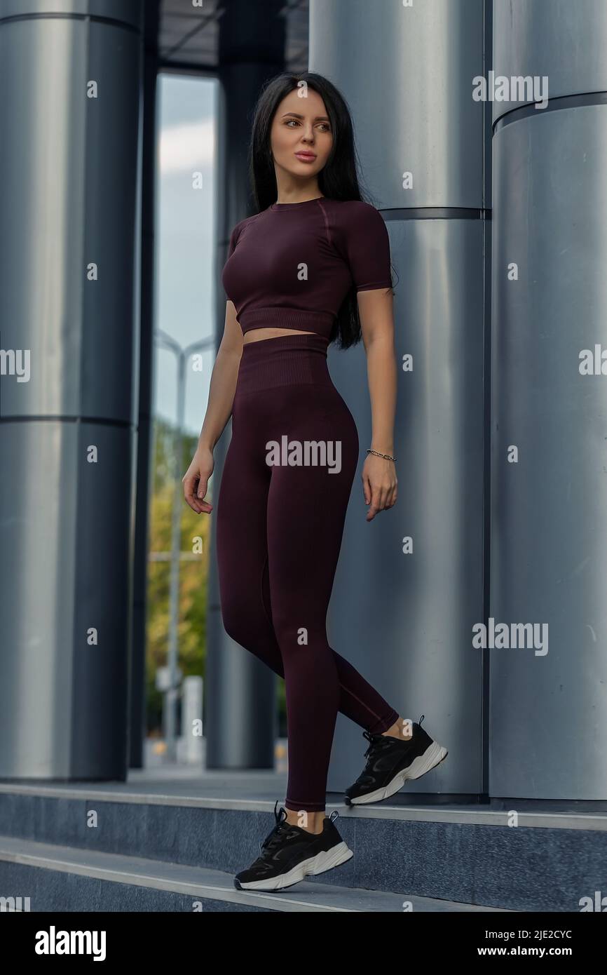 Fit girl purposefully descends the stairs against the backdrop of giant ...