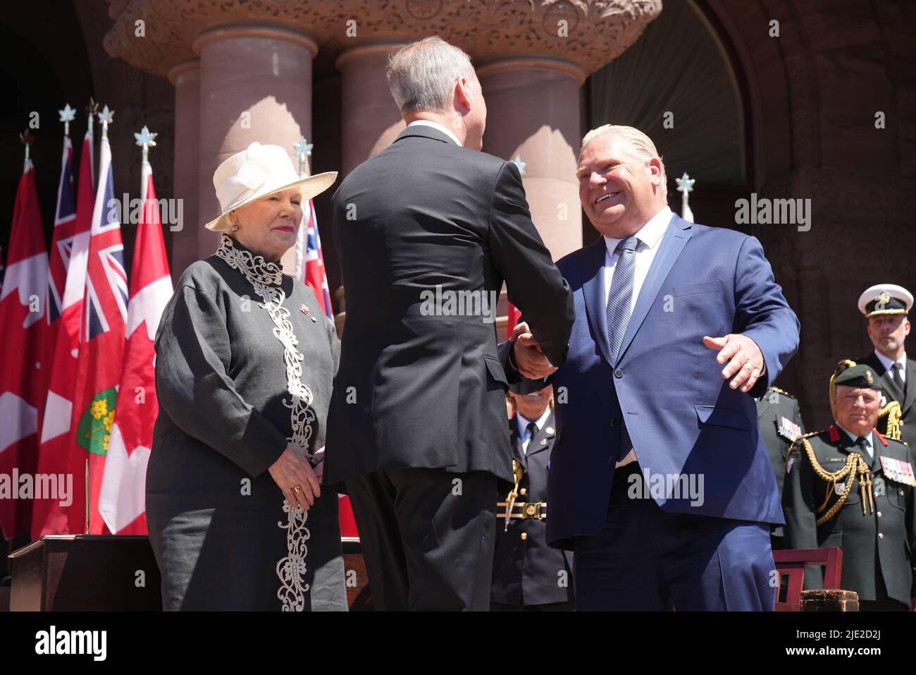 Minister of Finance Peter Bethlenfalvy, shakes hands with Premier Doug ...