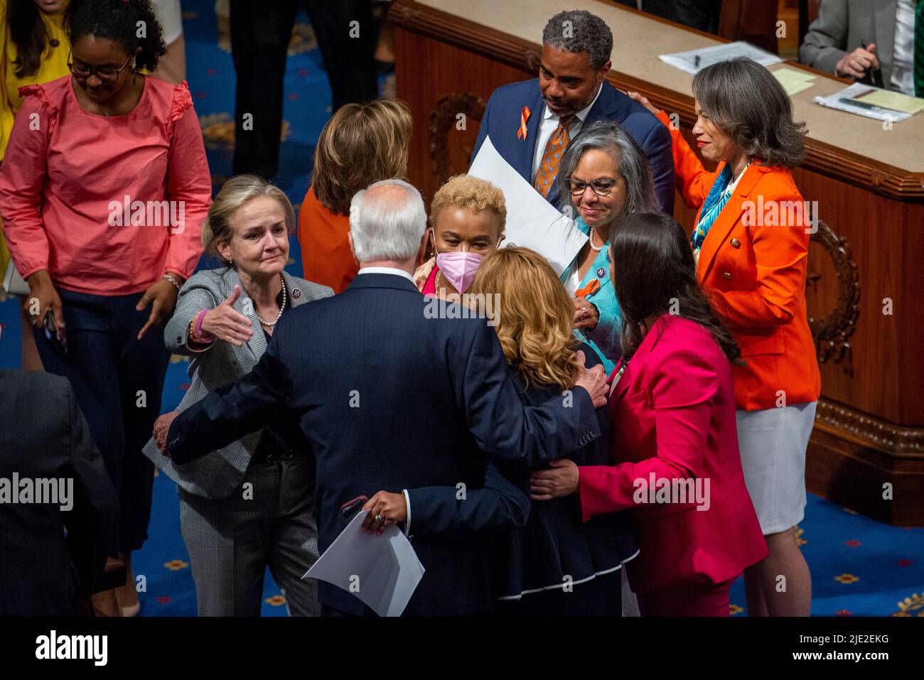 Members of Congress embrace on the floor of the House chamber following ...