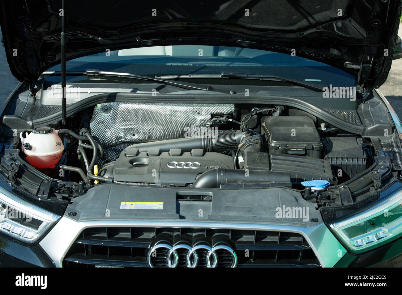 AUDI Q3 in black. Subcompact luxury crossover Audi Q3. Close-up of the engine and contents under ...