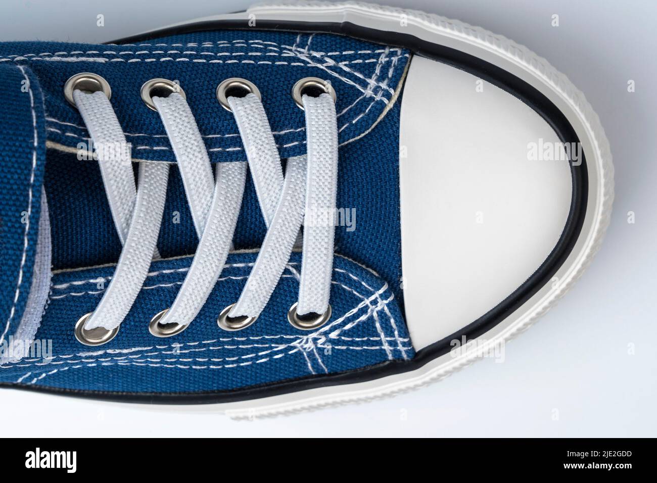 a blue sneaker on a white background. Classic sports shoes Stock Photo ...