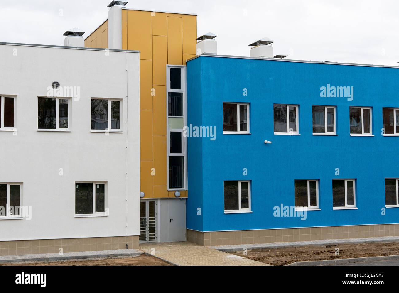 part of the facades of a new blue-yellow building with windows Stock ...