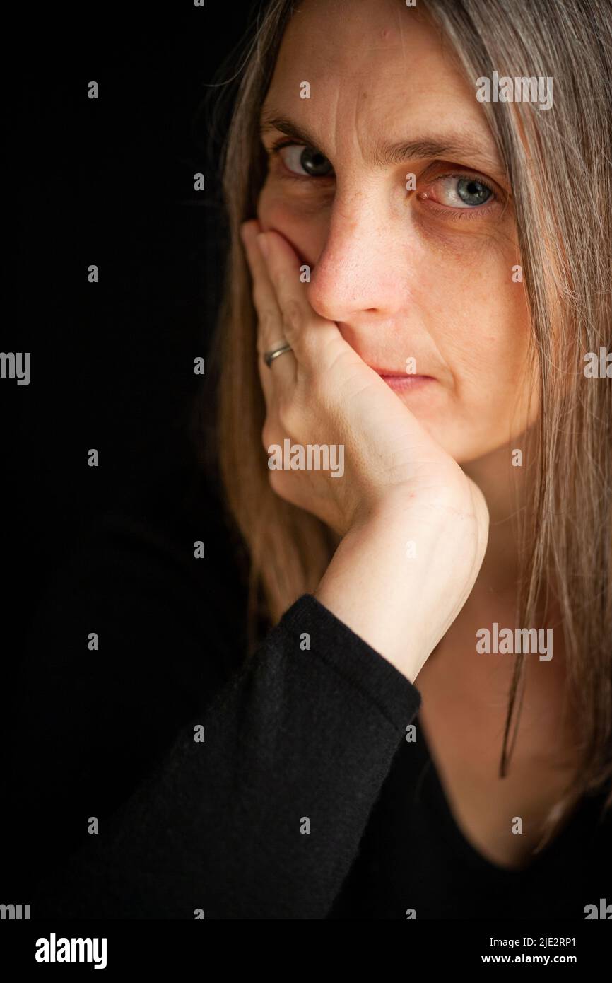 Quiet concern. A portrait of a mature woman looking candidly and with ...