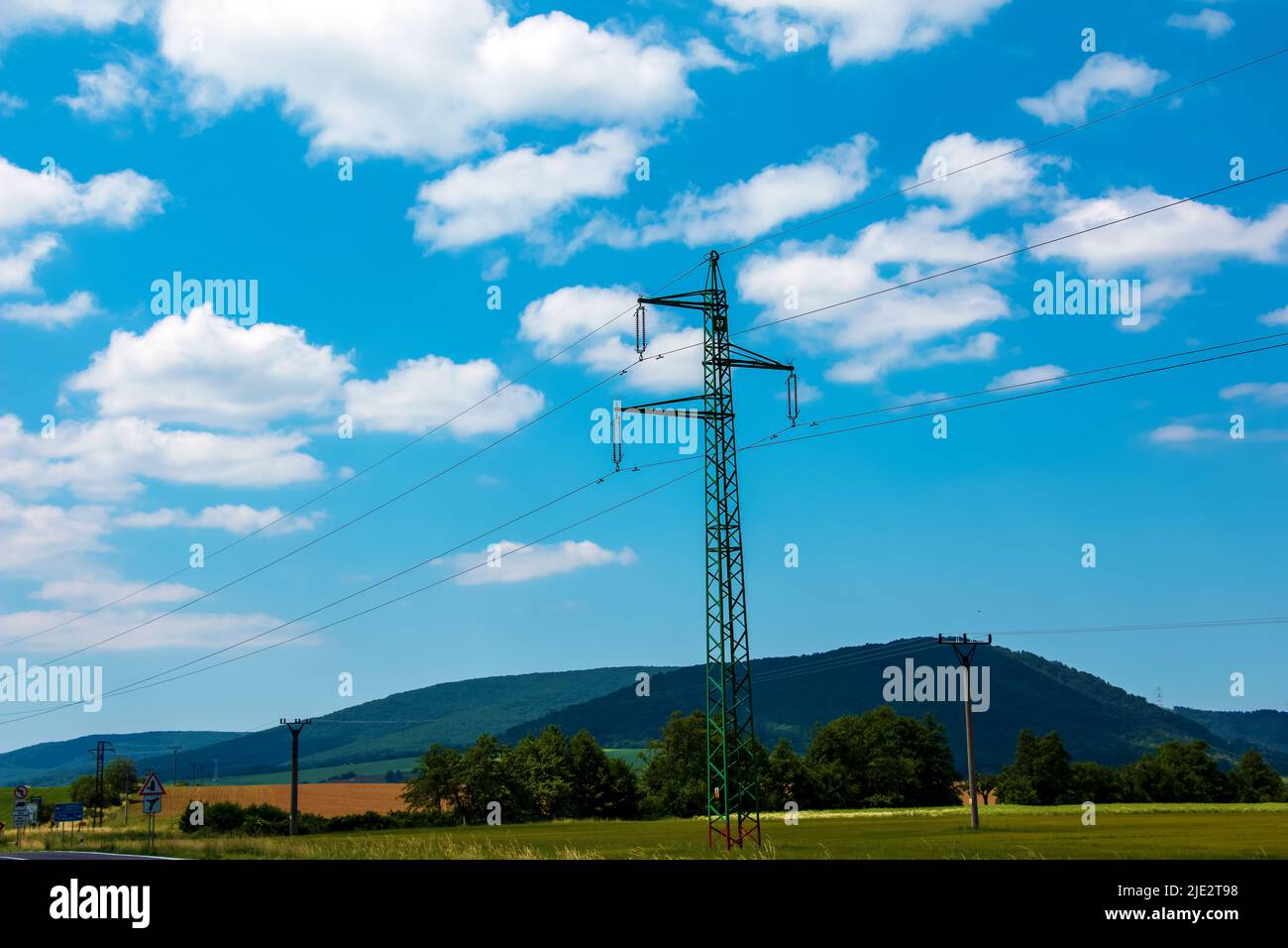 Electric pole power lines outgoing electric wires againts on cloud blue ...