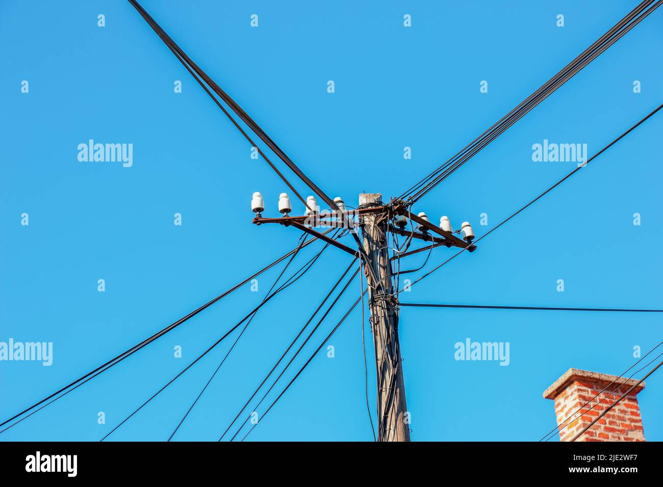 Electric pole power lines outgoing electric wires againts on cloud blue ...