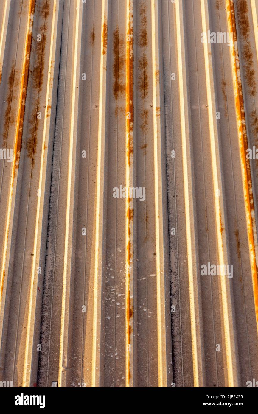 Background of rusty metal material mounted on a ceiling of a factory in ...