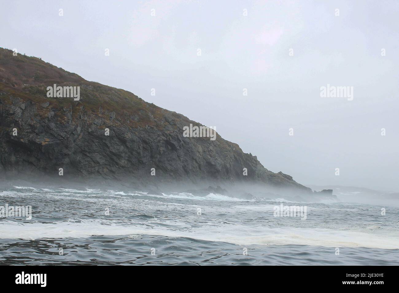 Wave crashing against small iceberg bit floating in sea Stock Photo - Alamy