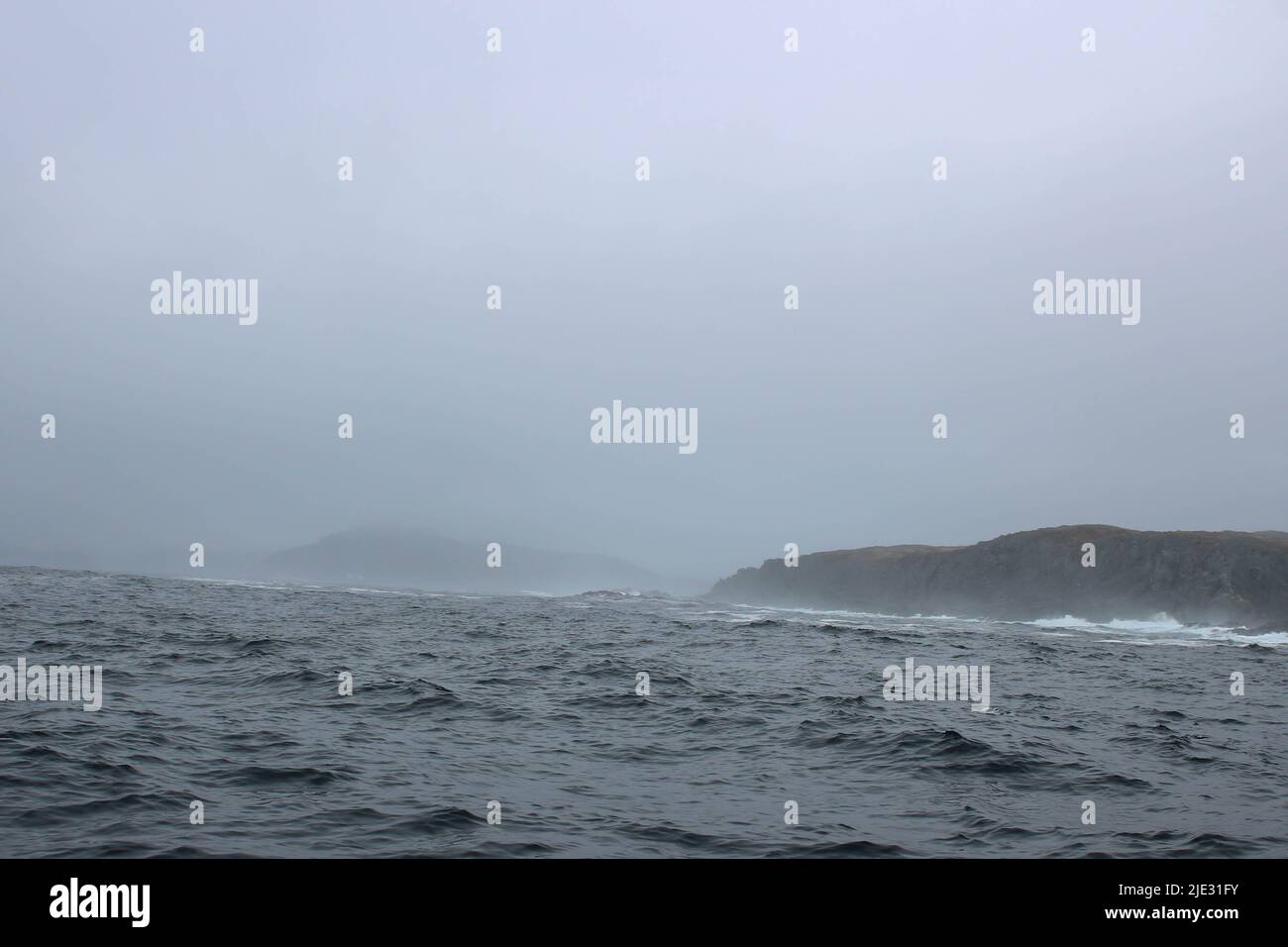 Wave crashing against small iceberg bit floating in sea Stock Photo - Alamy